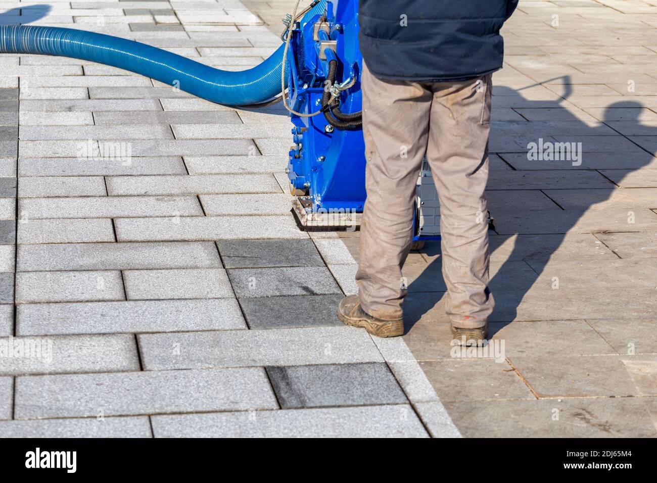 Surface prep work on granite blocks paving. Steel shot blasting ...