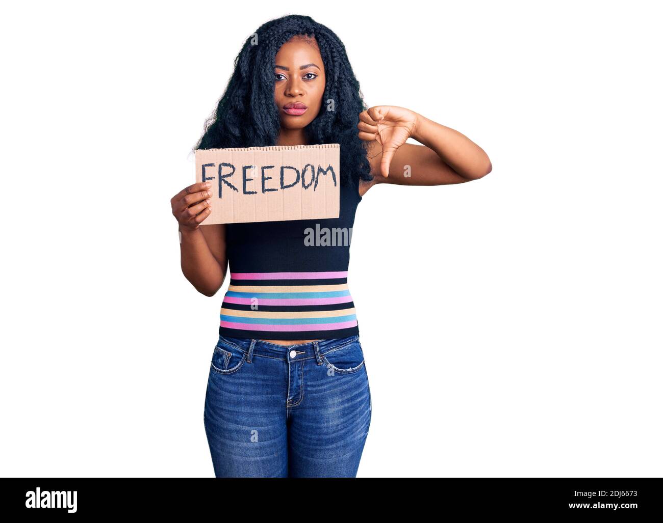 Beautiful african american woman holding freedom banner with angry face ...