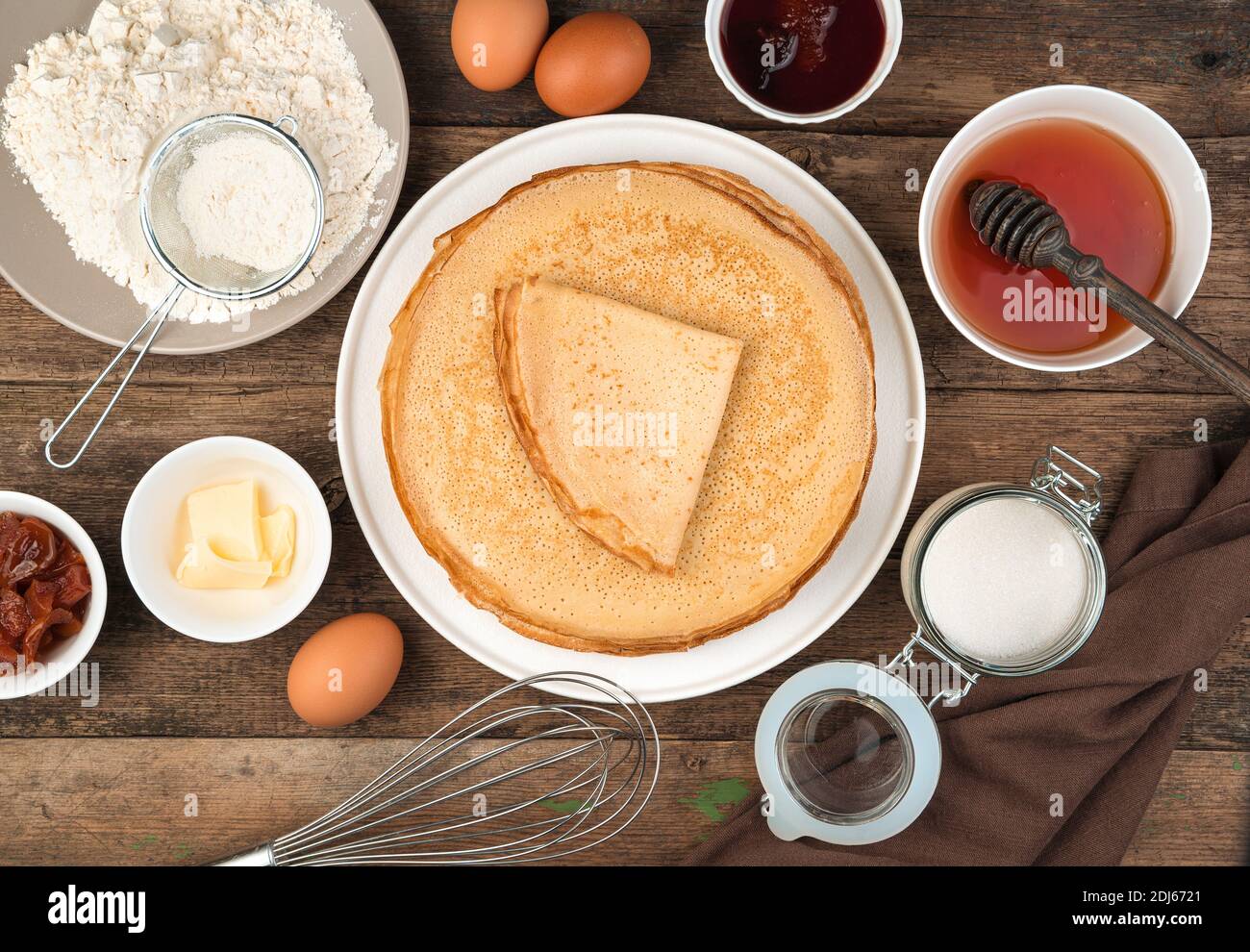 Cooking background with ingredients and pancakes on a brown background ...