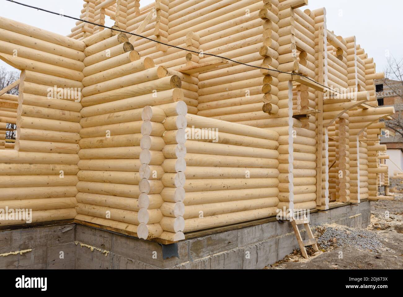 Construction of a Christian church made of wooden treated logs by hand ...