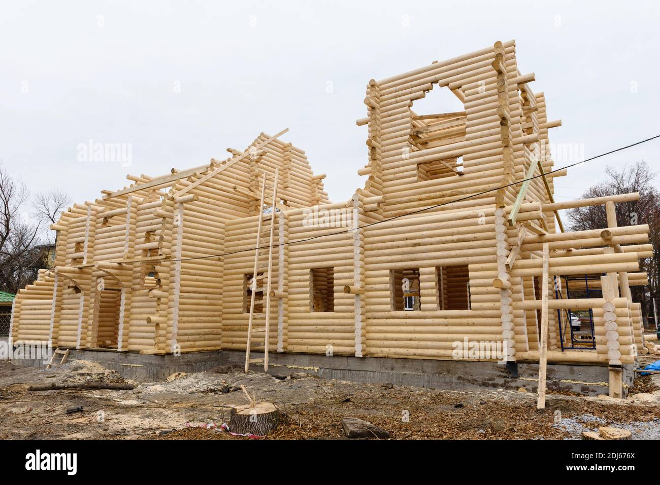 Construction of a Christian church made of wooden treated logs by hand ...
