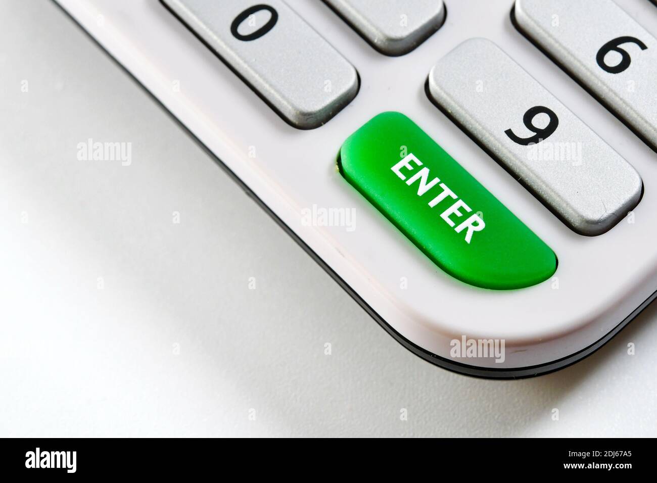 Close up view of the Enter key on an electronic calculator on a plain ...
