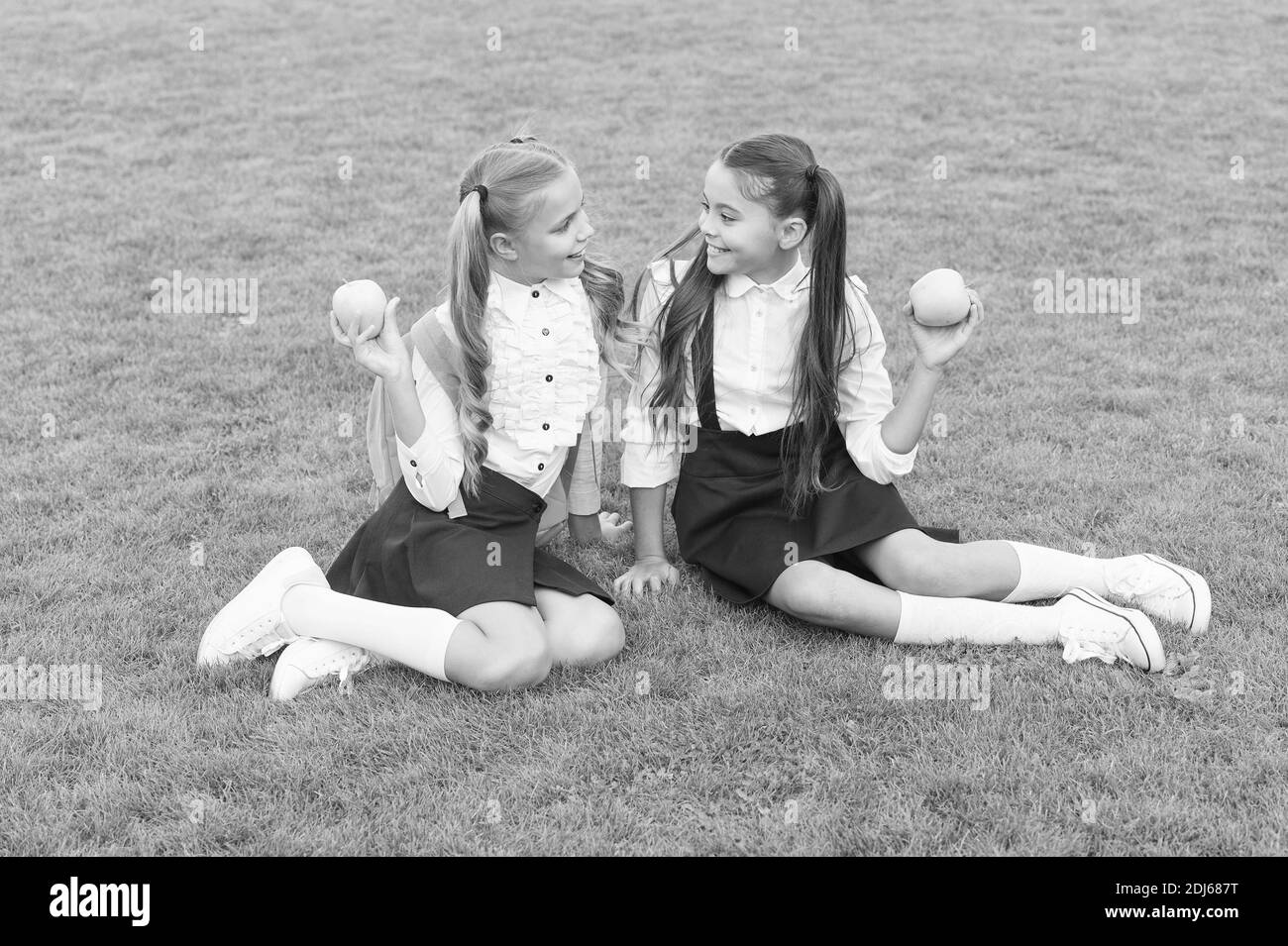 Little girls friends eat healthy school lunch, happy childhood concept ...
