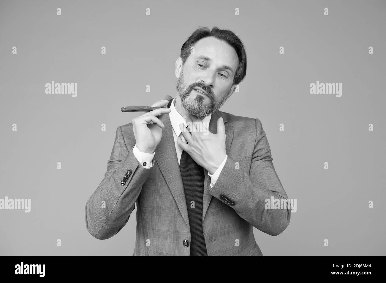 Man shaving straight razor grooming beard, confident blade movement ...