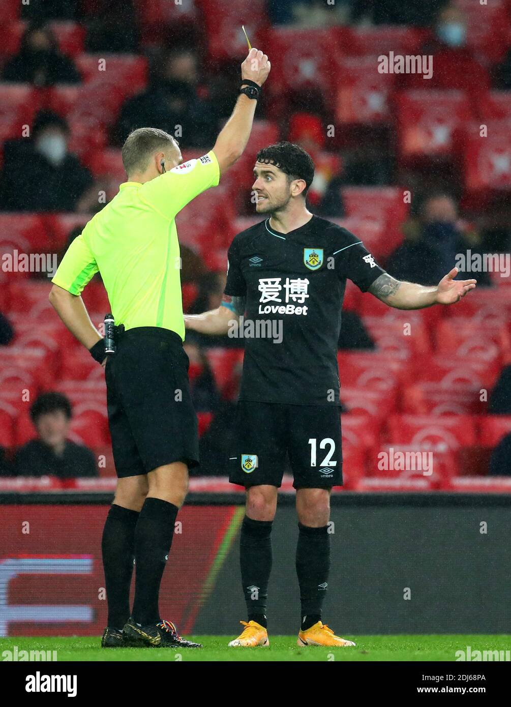 Burnley's Robbie Brady is shown the yellow card by referee Graham Scott ...
