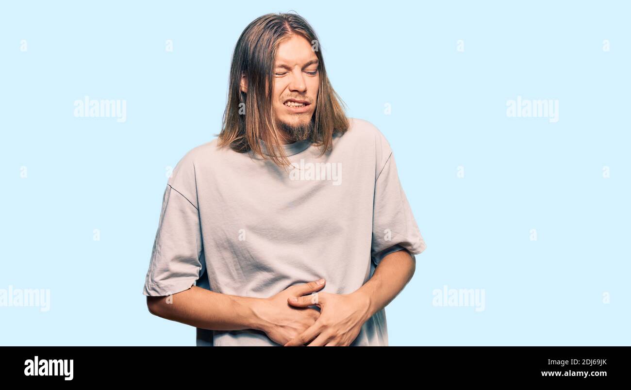 Handsome caucasian man with long hair wearing casual clothes with hand ...