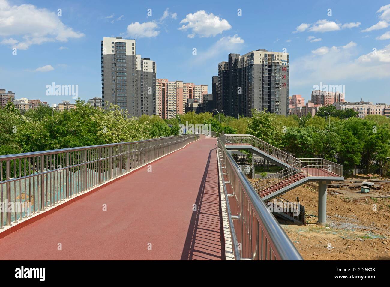 View along a footbridge to apartments and flats in western Beijing ...