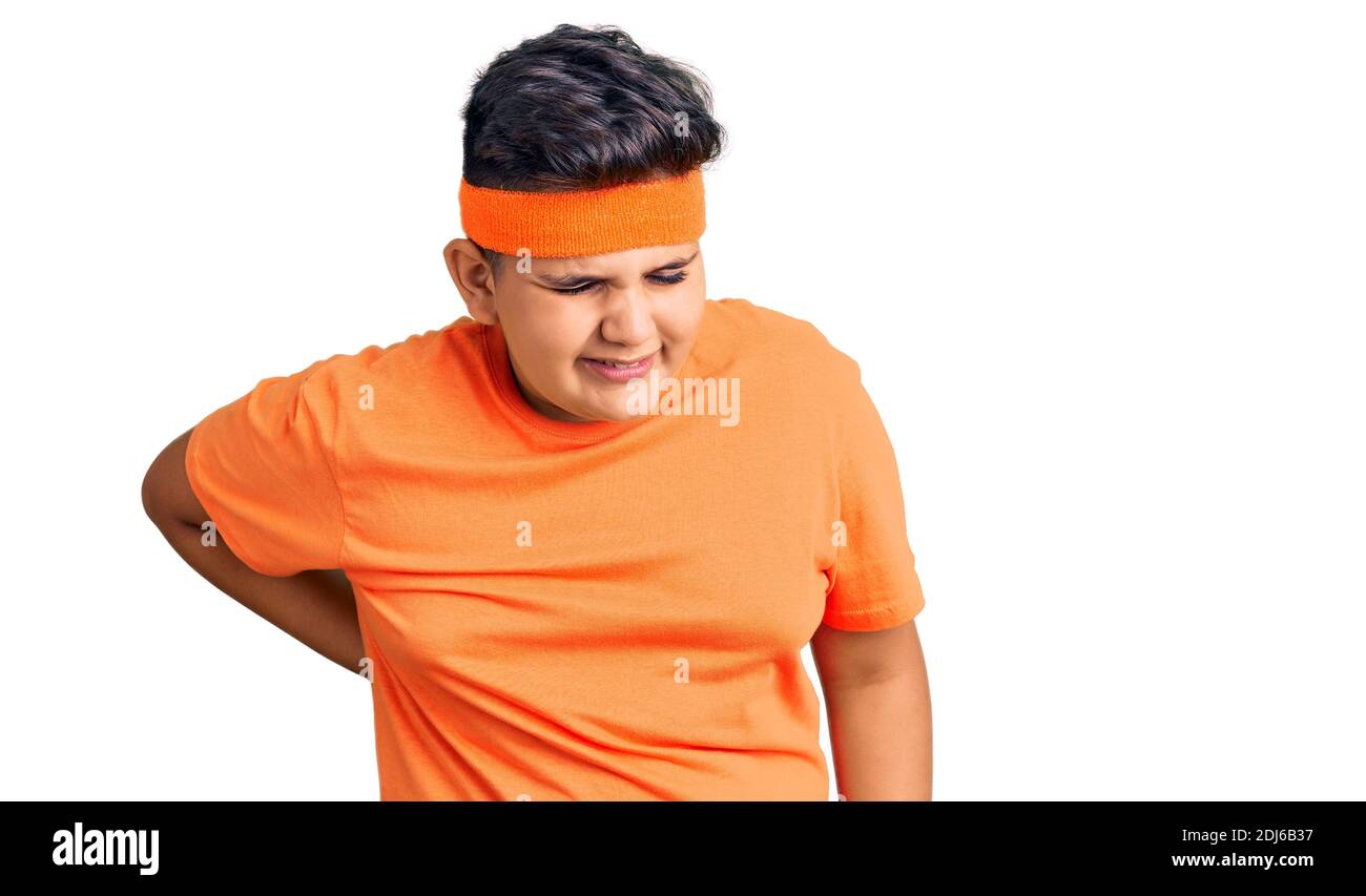 Little boy kid wearing sportswear suffering of backache, touching back ...