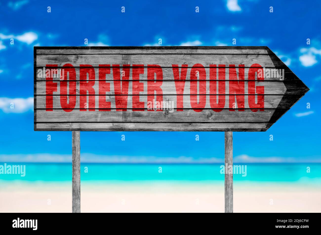 Red Forever Young sign with on beach background Stock Photo - Alamy