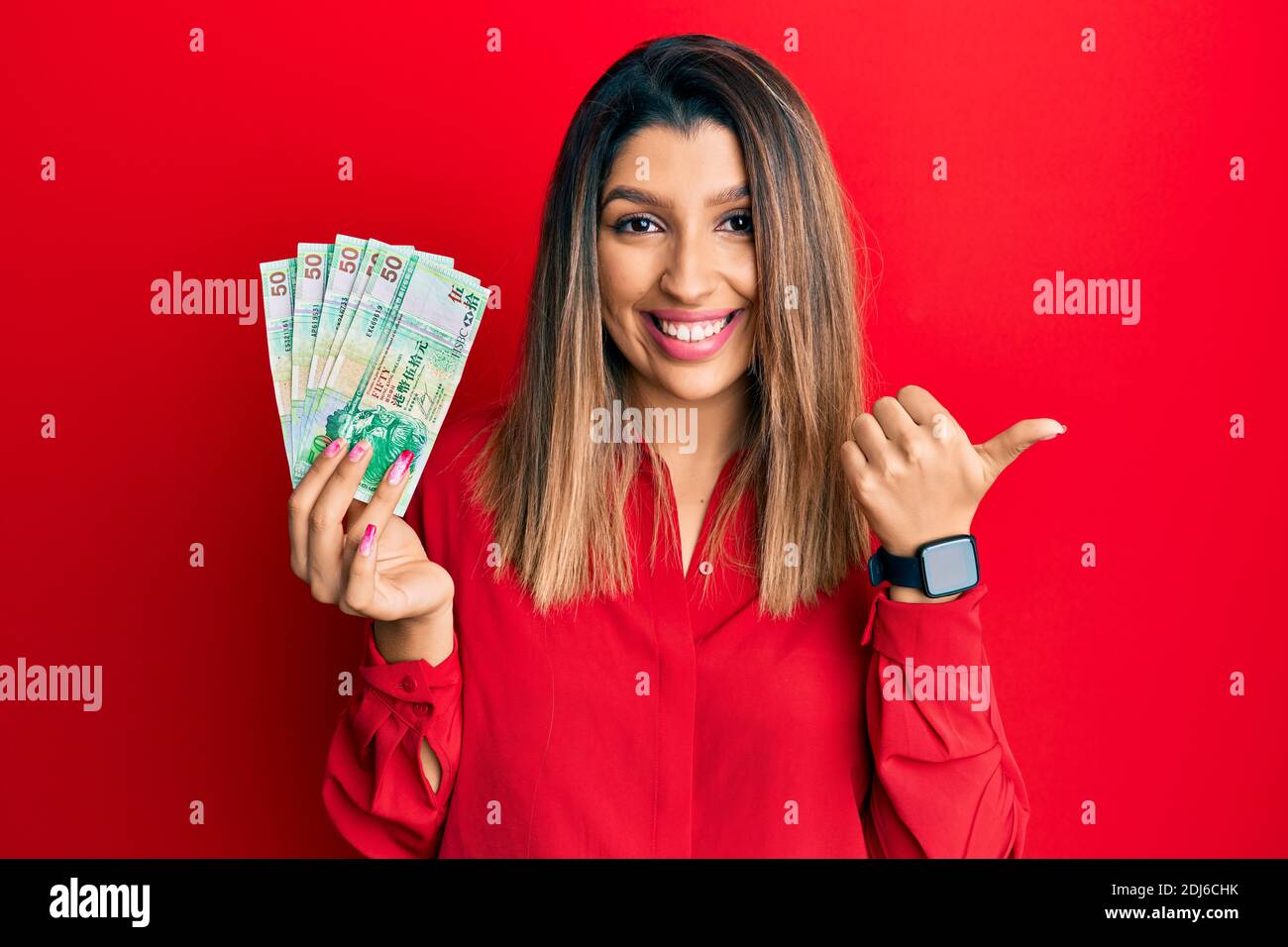Beautiful brunette woman holding hong kong 50 dollars banknotes ...