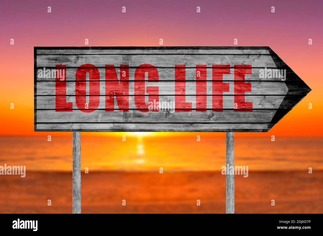 Red Long Life wooden sign with a beach background Stock Photo - Alamy