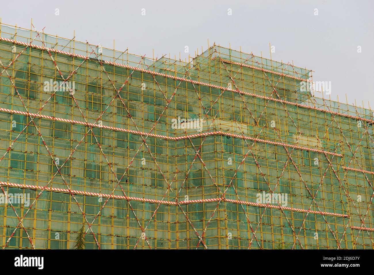 Scaffolding covers a building under renovation in central Beijing ...
