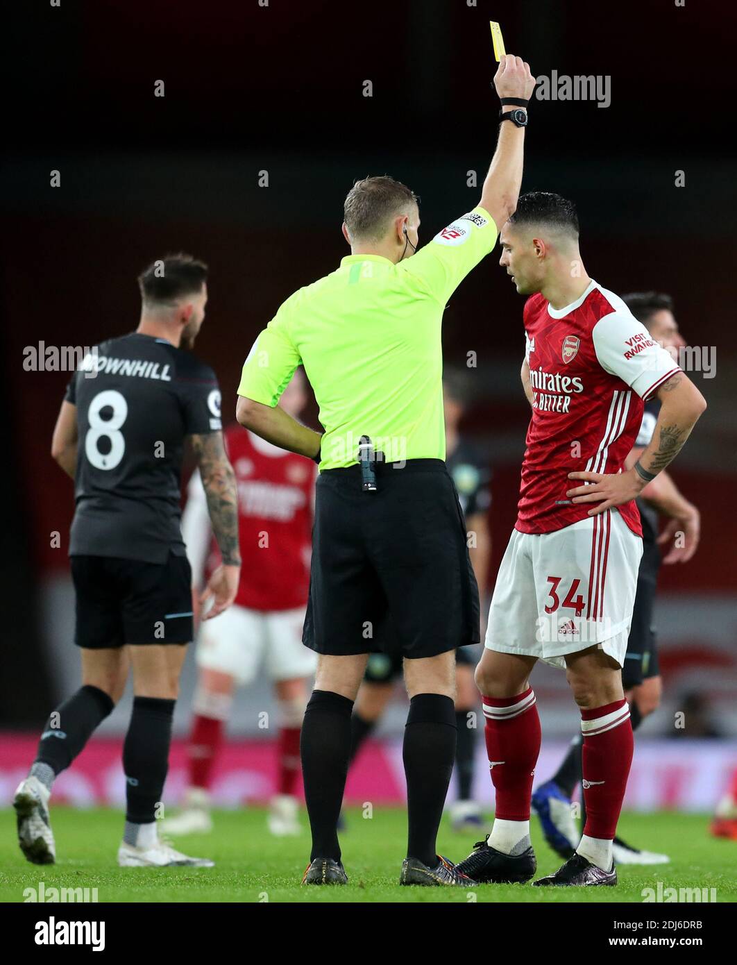 Arsenal's Granit Xhaka (right) is shown a yellow card by referee Graham ...