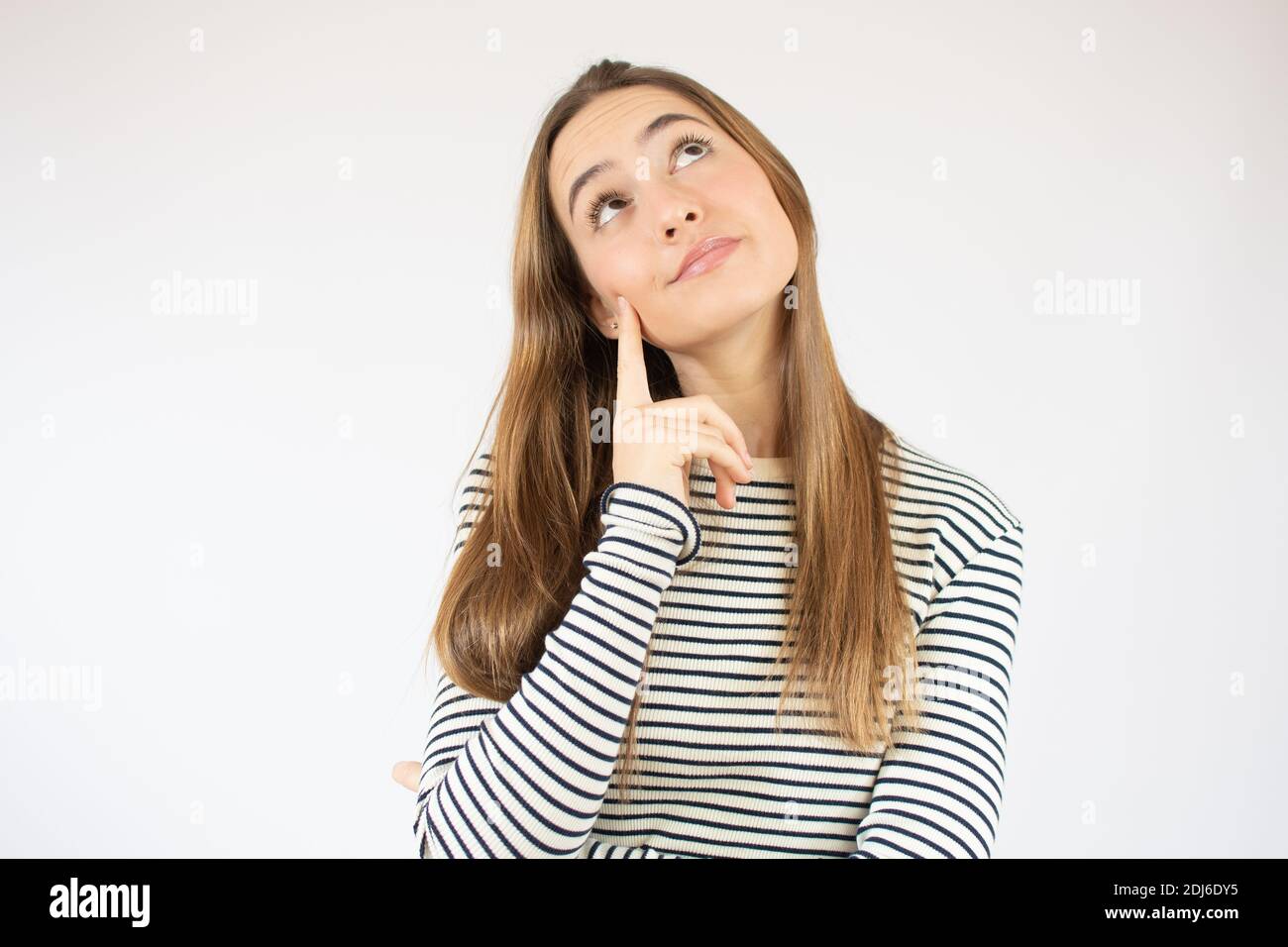 Image of thinking young woman standing isolated over white background ...