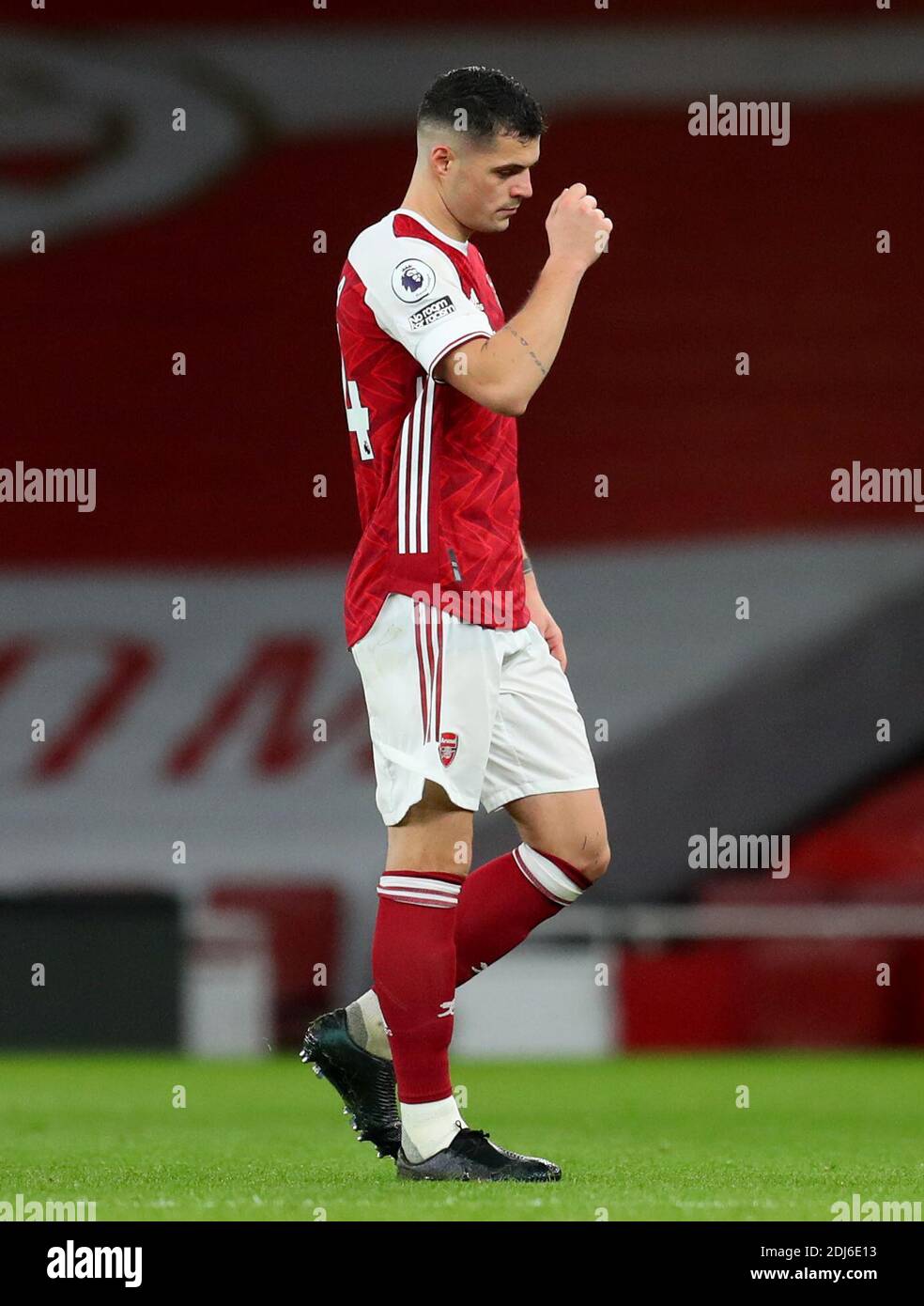 Arsenal's Granit Xhaka walks off the pitch dejected after being shown ...