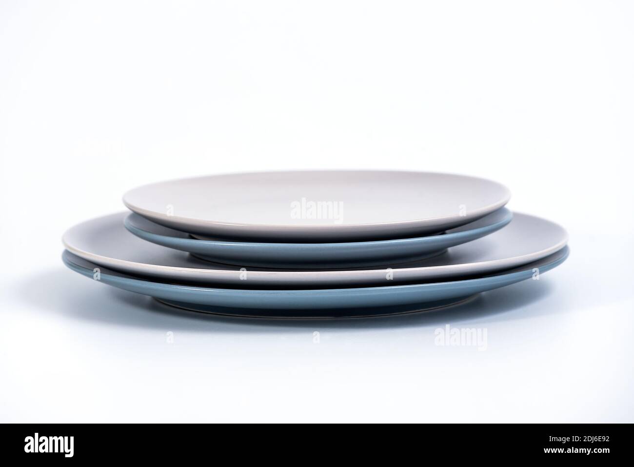 Stack of Dish Sets - Navy Blue and Grey plates isolated on white ...