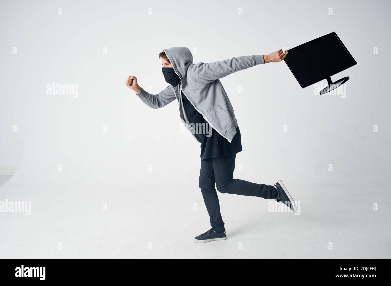 man steals monitor running away pursuit theft Stock Photo - Alamy