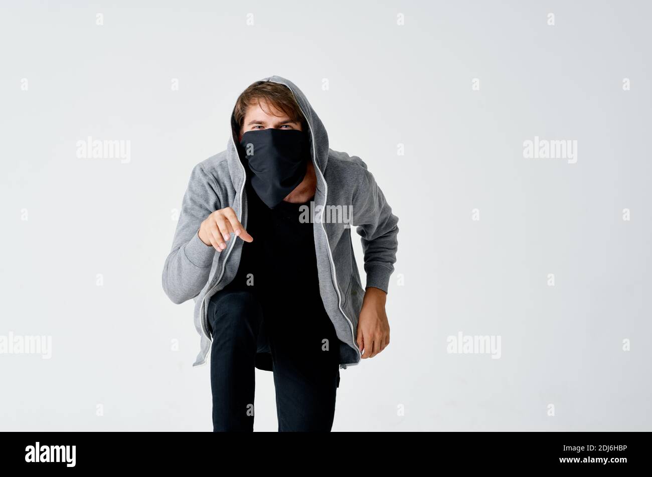 male thief in hood hidden mask tiptoe isolated fund Stock Photo - Alamy