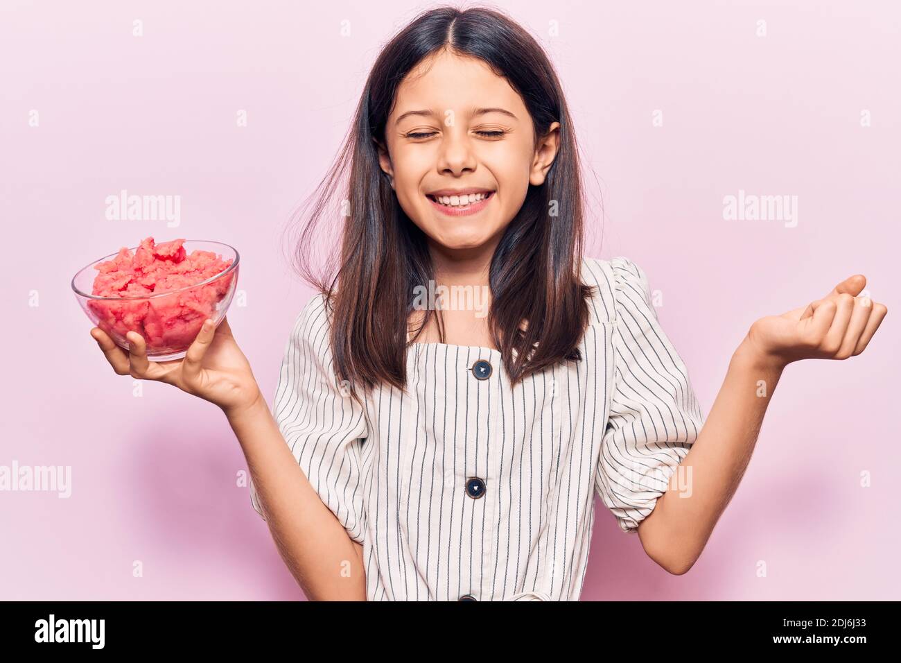 Beautiful child girl holding ice cream screaming proud, celebrating ...