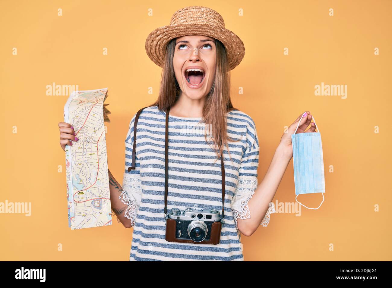 Beautiful caucasian tourist woman holding coronavirus safety mask angry ...