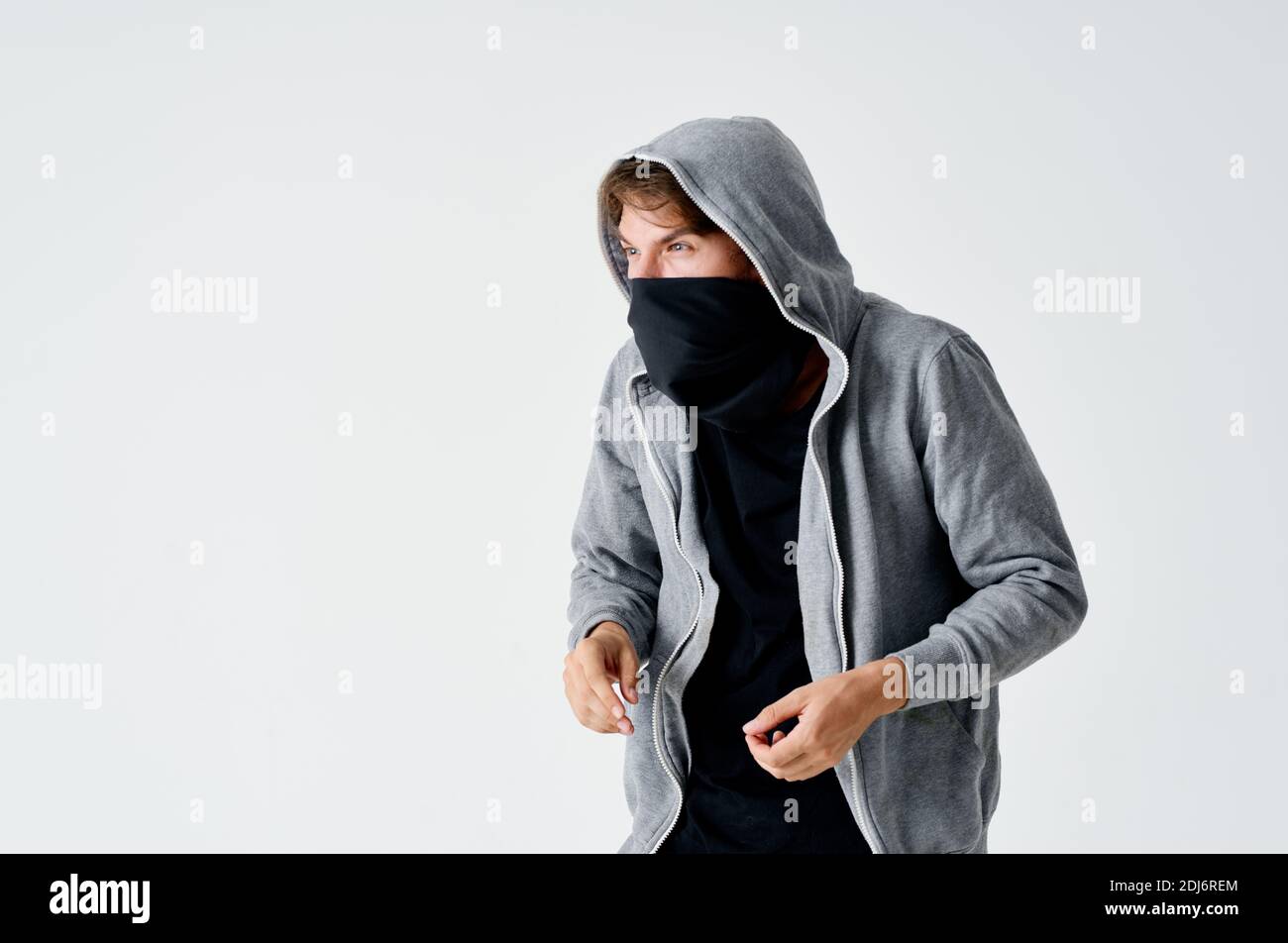 male hacker in a gray sweater stealing black mask on his face Stock ...