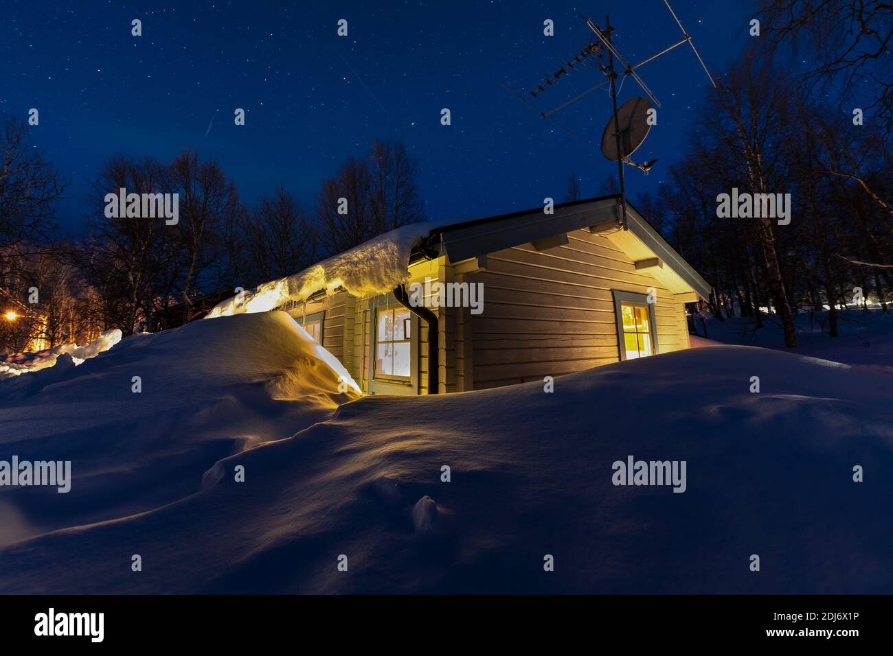 Scenic night photo of typical Swedish wooden mountain cabin with stars ...