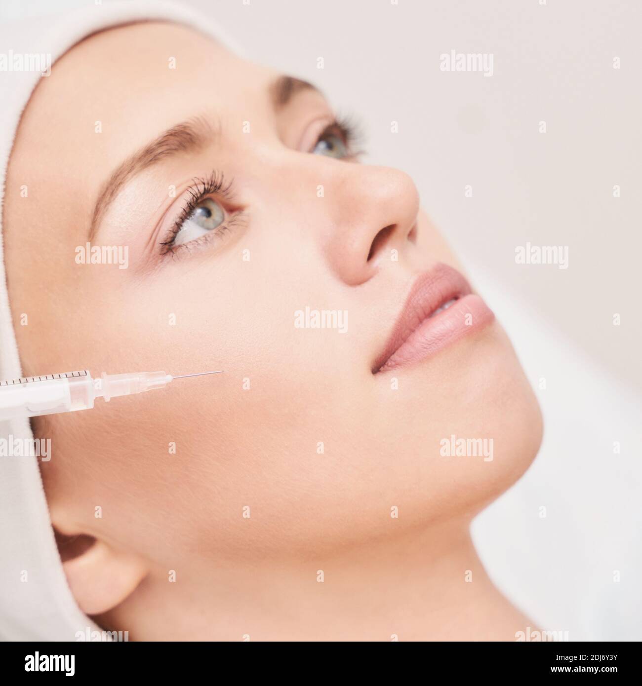 Cheek injection at spa salon. Doctor hands. Closeup view. Pretty female ...