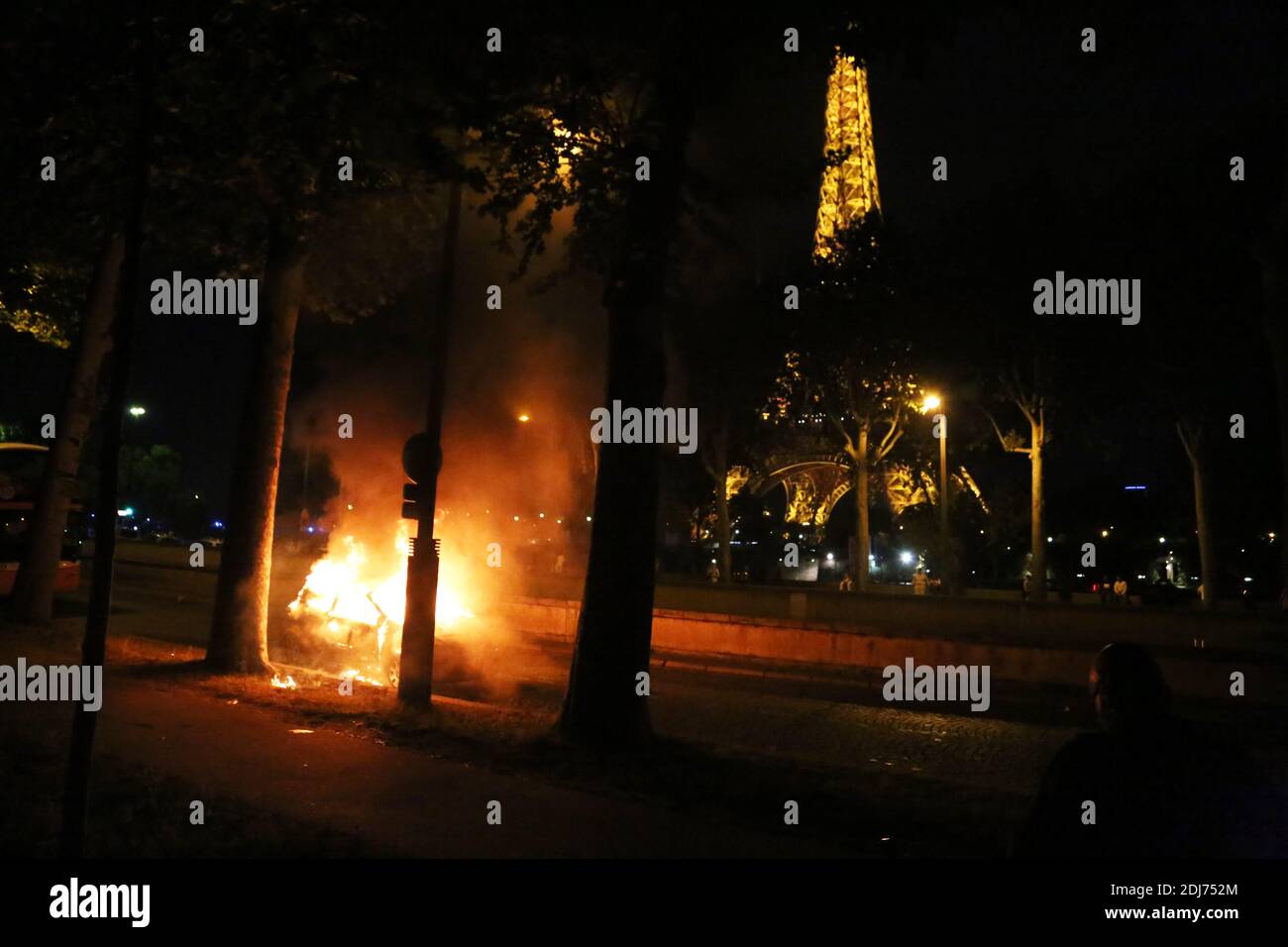 French riot policemen stand near a fire during clashes near the fan ...