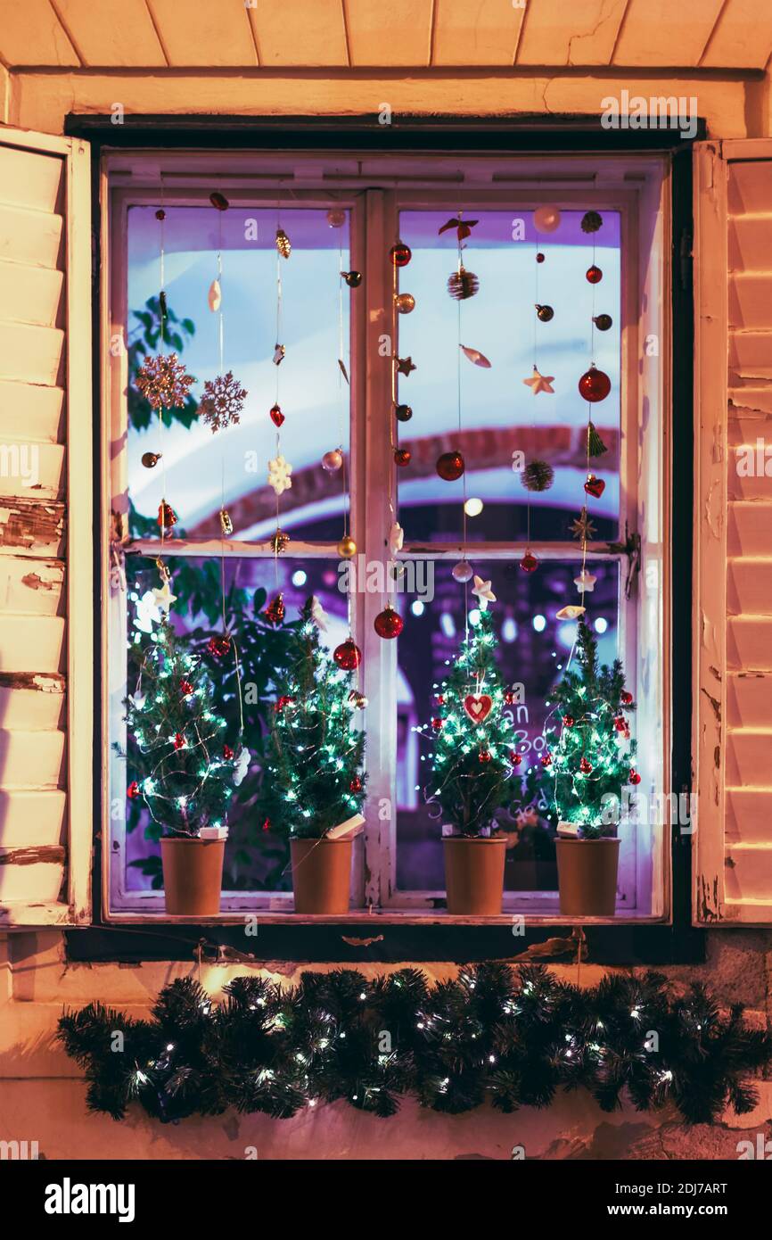 Window decorated for Christmas, view from outside. Winter holidays ...