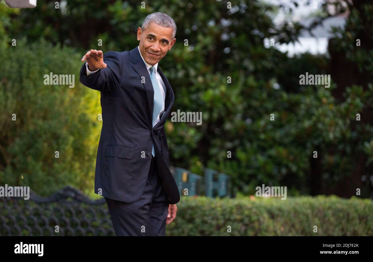 U.S. President Barack Obama wave as he walks to Marine One while ...