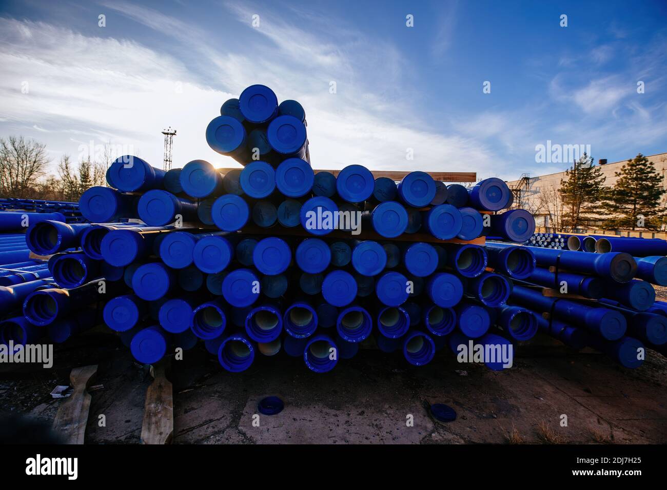 Stack of cast iron pipes in loading area waiting for transportation ...