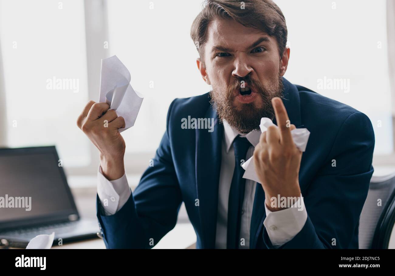 Aggressive man with sheets of paper in hands stress irritability ...