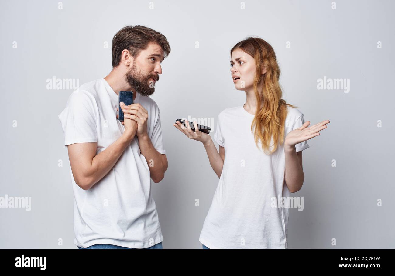 young couple with phones technology communication friendship lifestyle ...