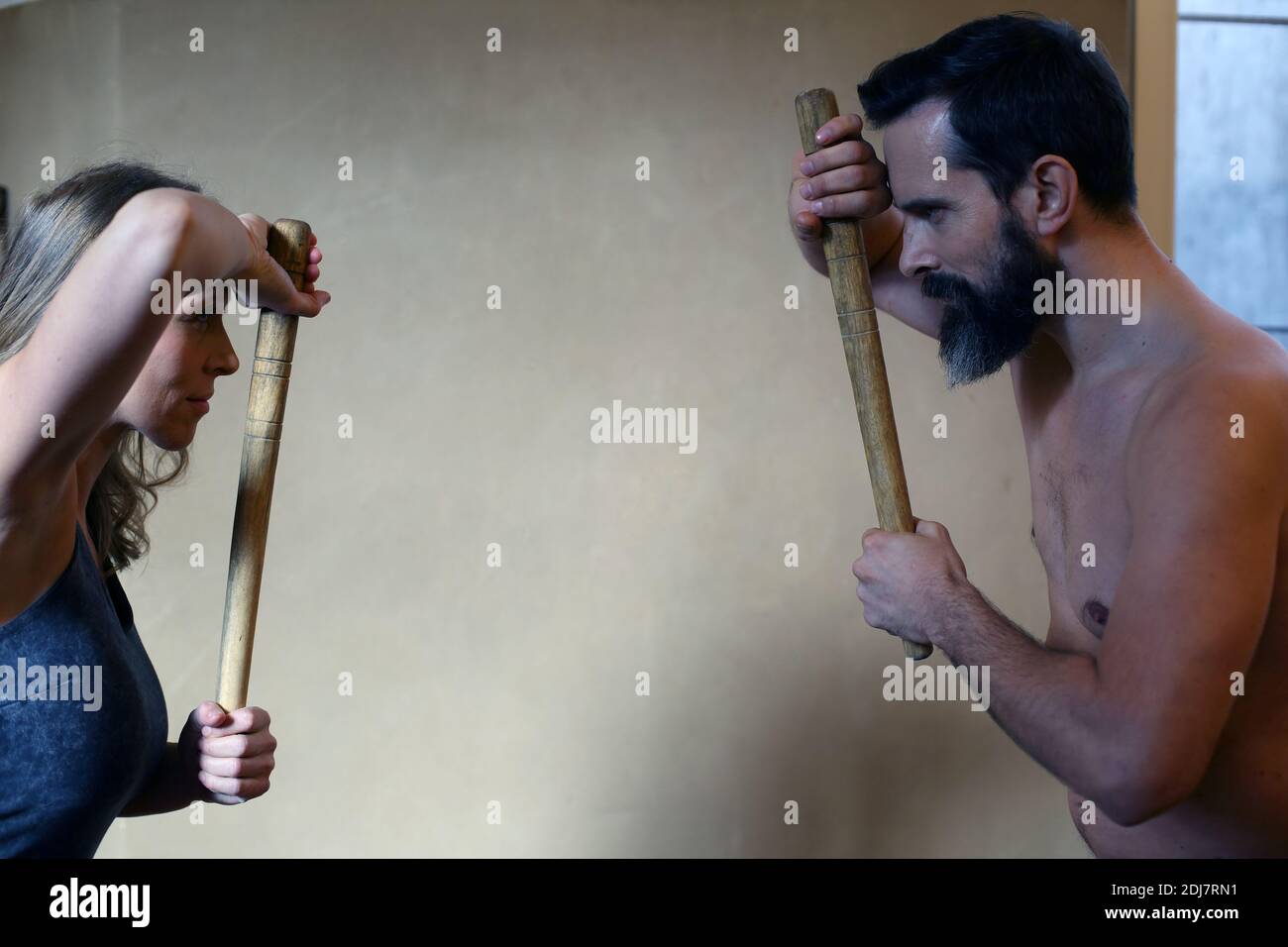 young woman practicing ancient martial art of stick fighting, attacking ...