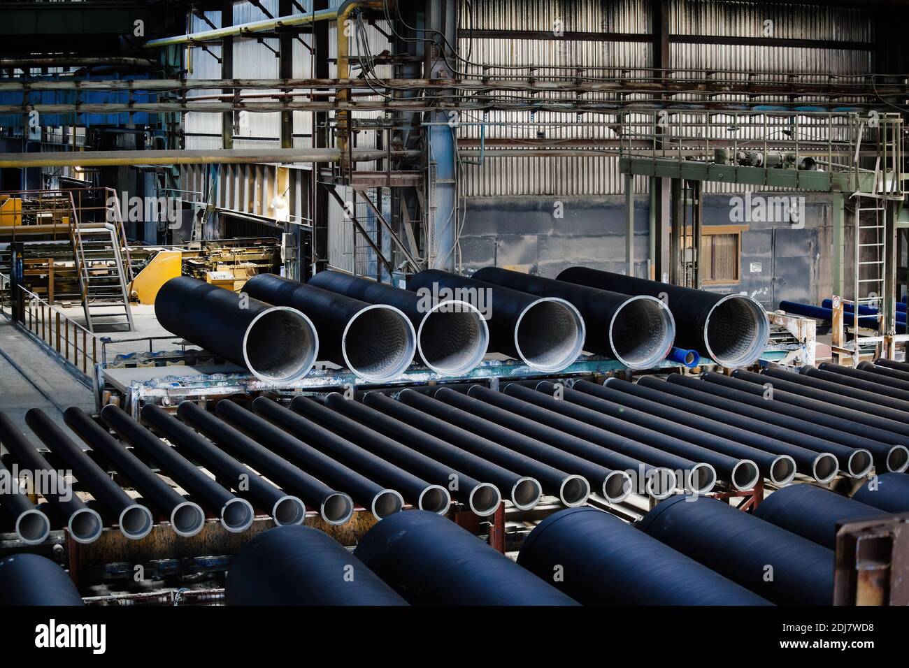 New cast iron pipes for pipeline construction in warehouse Stock Photo ...