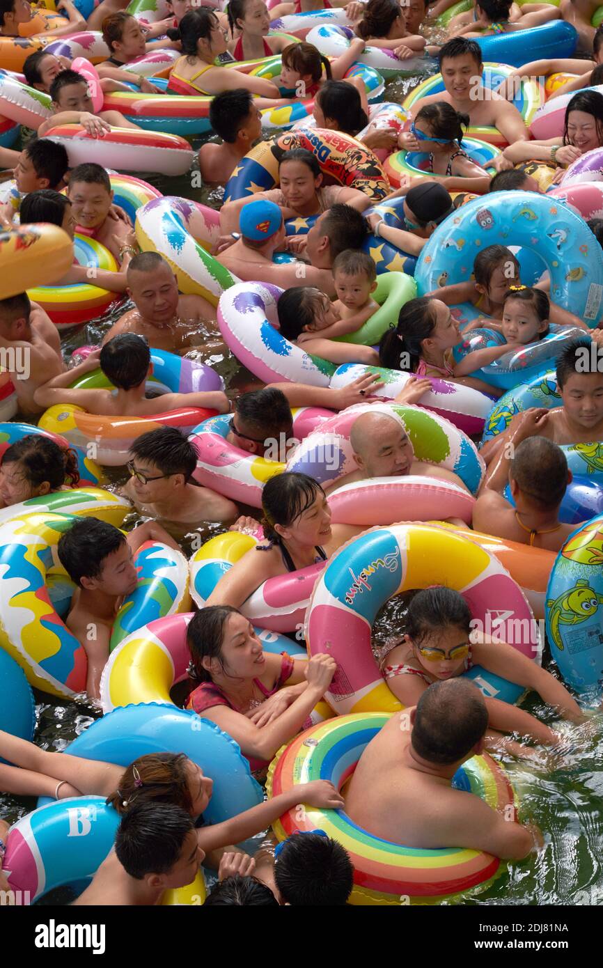 Thousands of people avoid the heat and enjoy the water at the Chinese ...