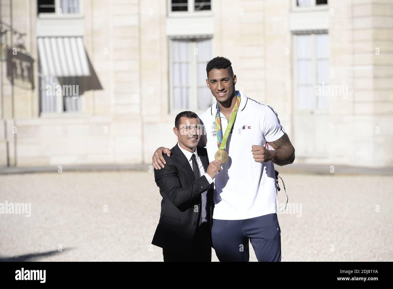 France's gold medallist boxer Tony Yoka (R) and French former boxer ...