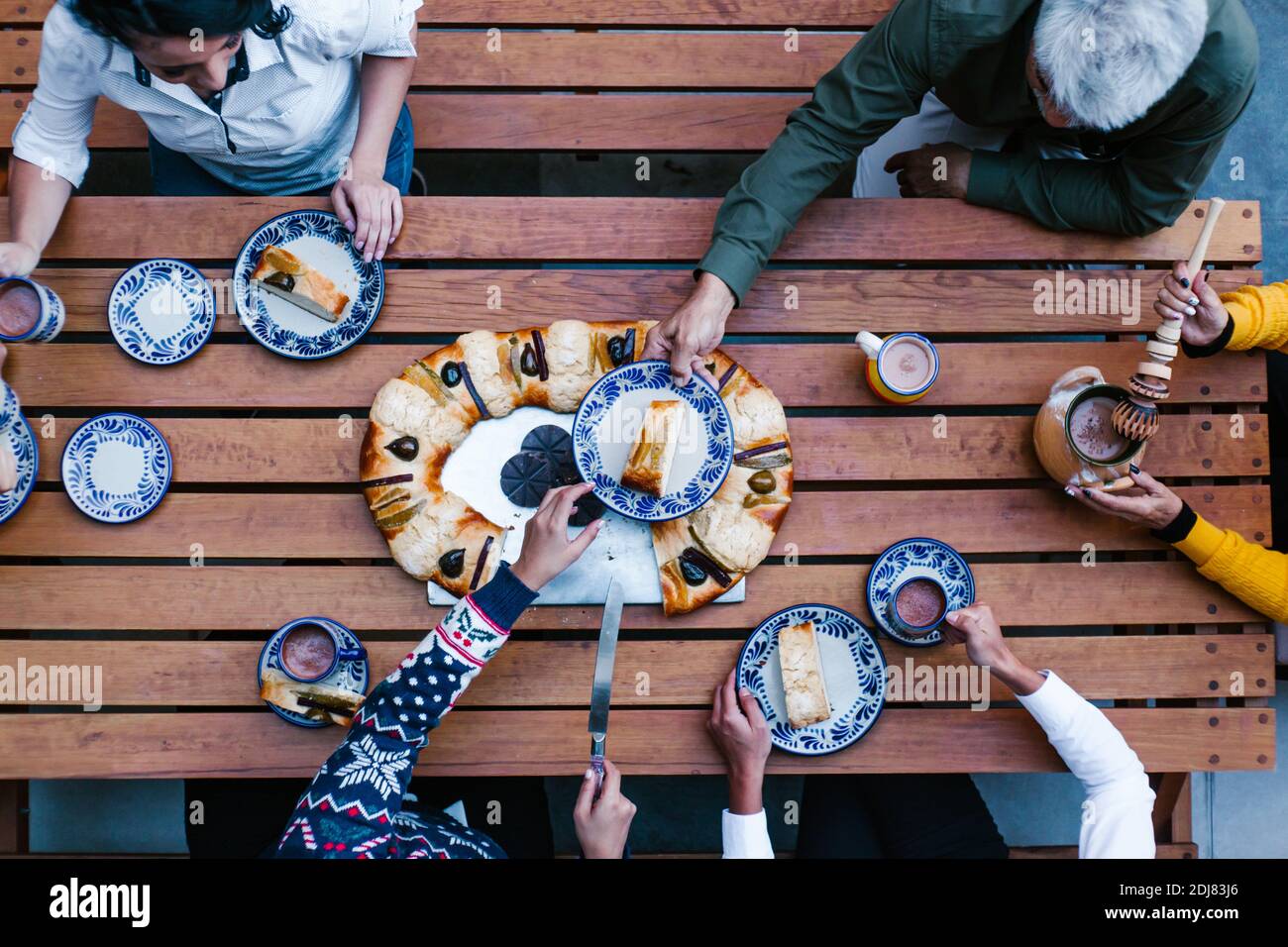 Mexican people eating Rosca de reyes or Epiphany cake, Roscon de reyes ...