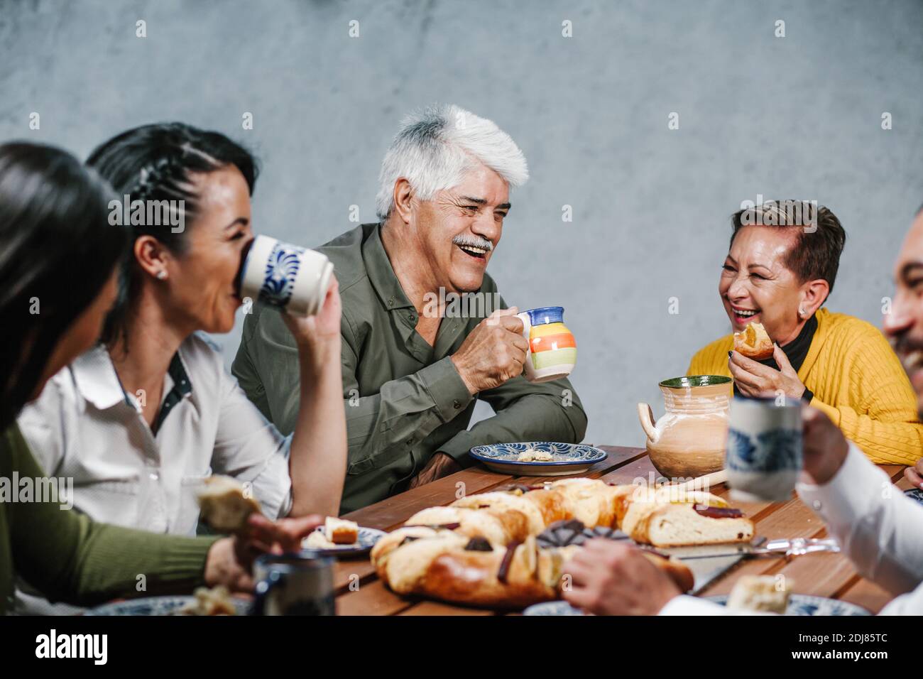 Mexican family eating Rosca de Reyes or Epiphany cake, Roscon de reyes ...