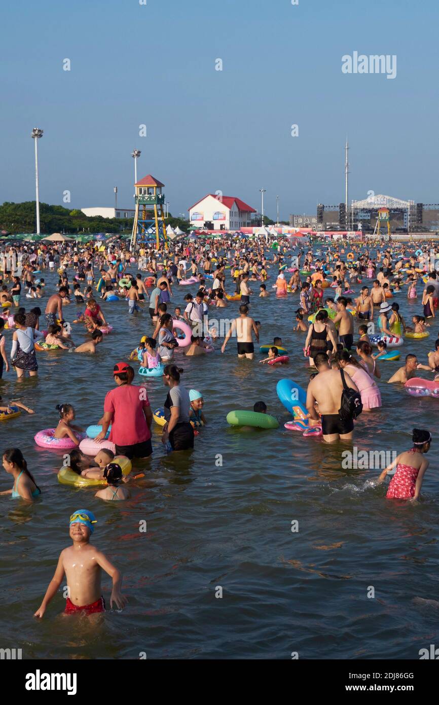 Chinese tourists enjoy an artificial beach at the Bihai Jinsha Beach in ...