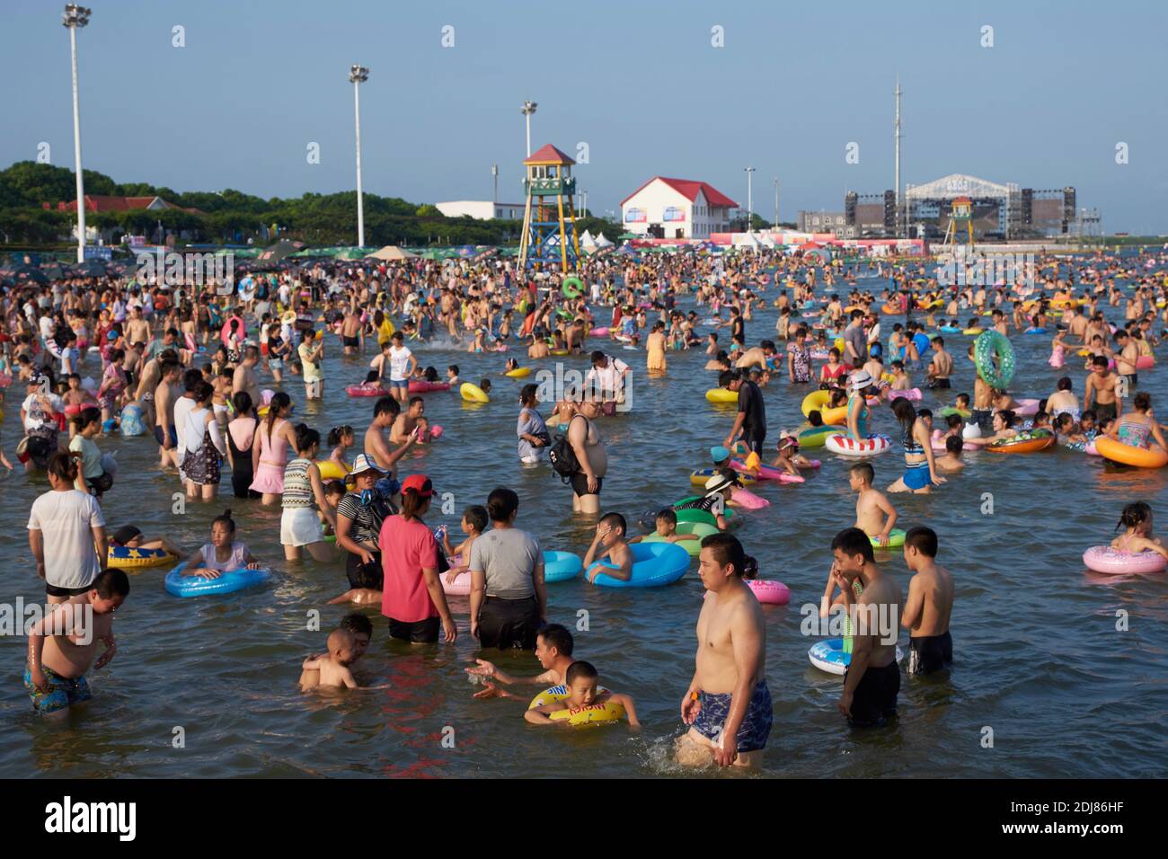 Chinese tourists enjoy an artificial beach at the Bihai Jinsha Beach in ...