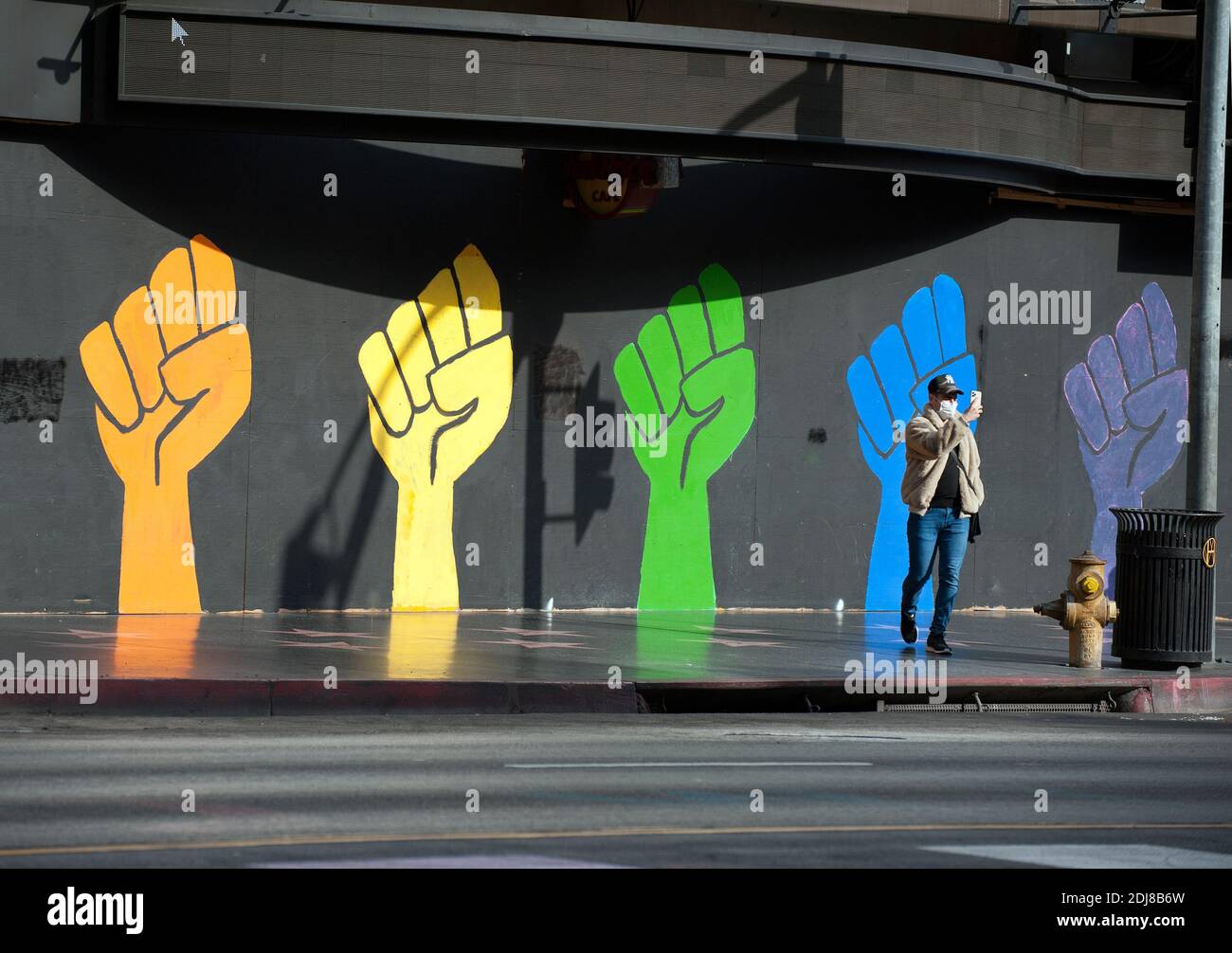 Man with a face mask taking a selfie on Hollywood Blvd. in front of a ...