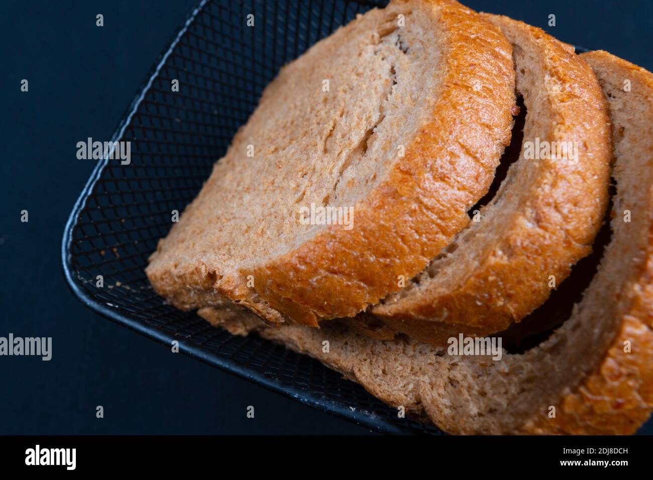 Whole grain bread on black background Stock Photo - Alamy