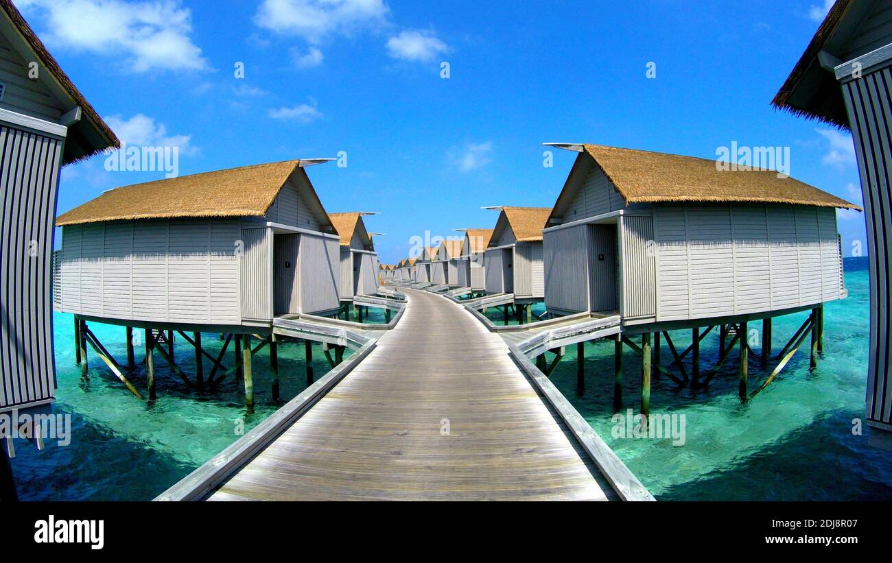 Beautiful resort with wooden huts built on the clear water of Maldives ...