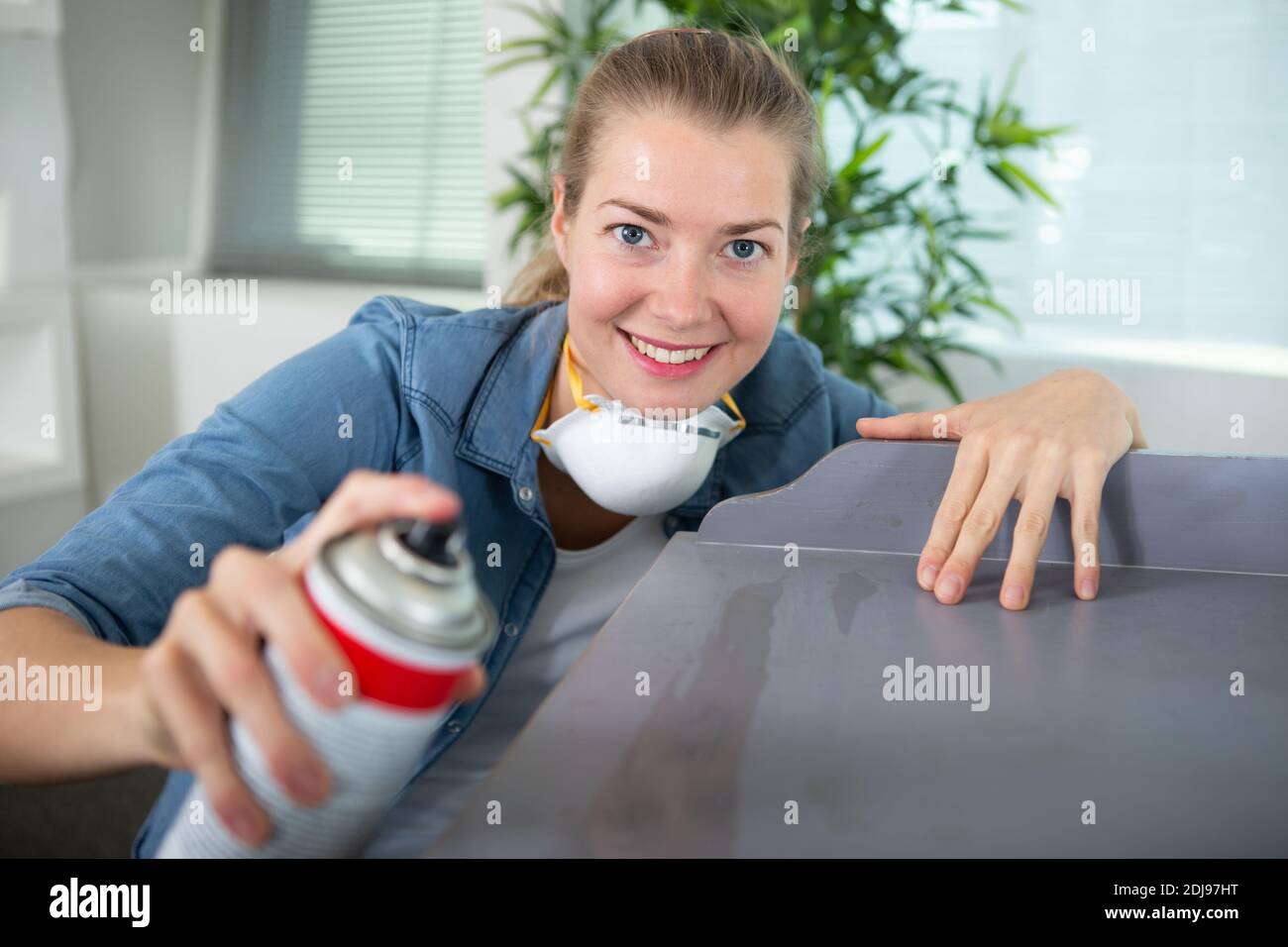 woman with mask spraying furniture Stock Photo - Alamy
