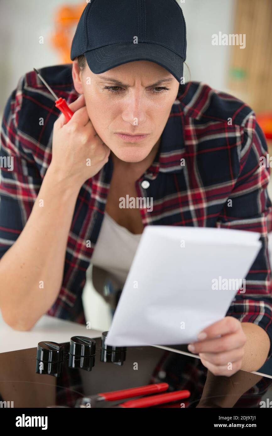 Reading a manual and fixing hi-res stock photography and images - Alamy