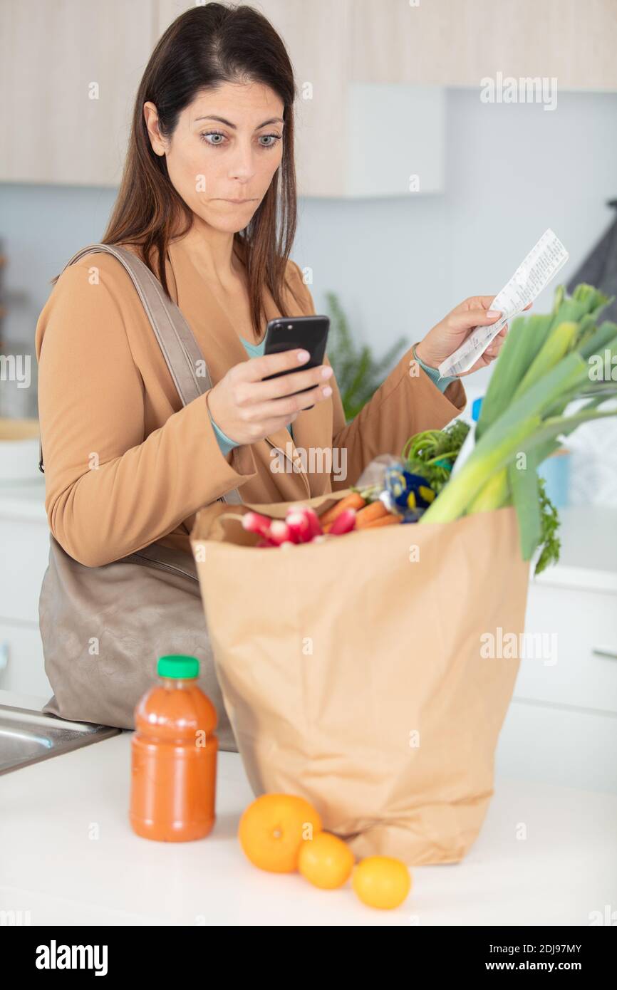 woman checking a long grocery receipt Stock Photo - Alamy