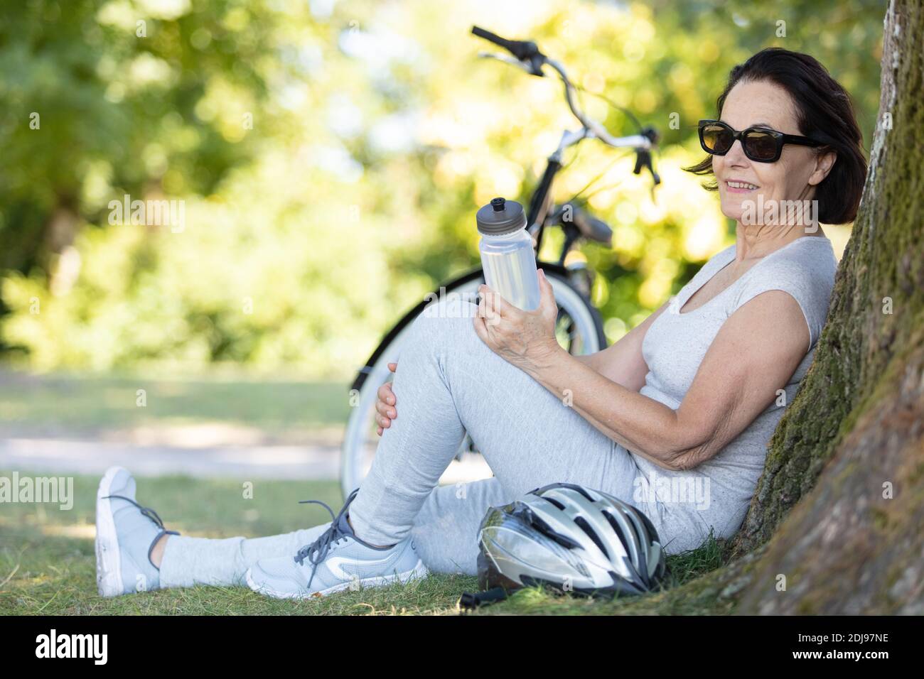senior woman cyclist taking a break Stock Photo - Alamy