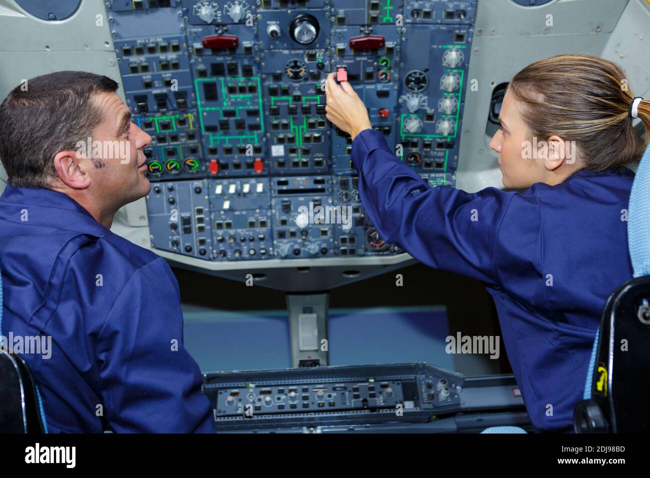 female apprentice with superior in aircraft cockpit Stock Photo - Alamy