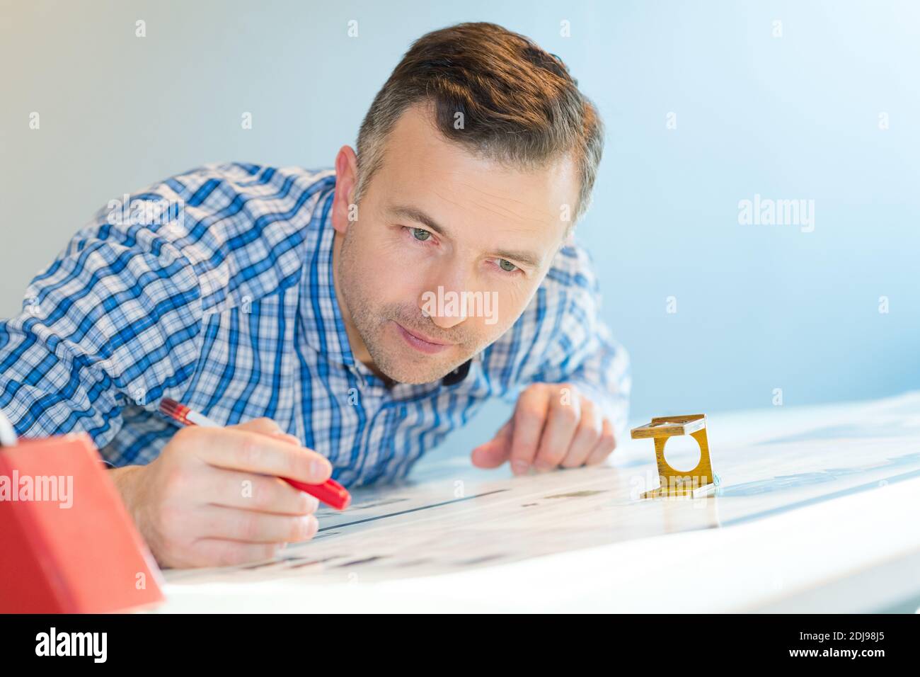 portrait man at work using a magnifying glass Stock Photo - Alamy